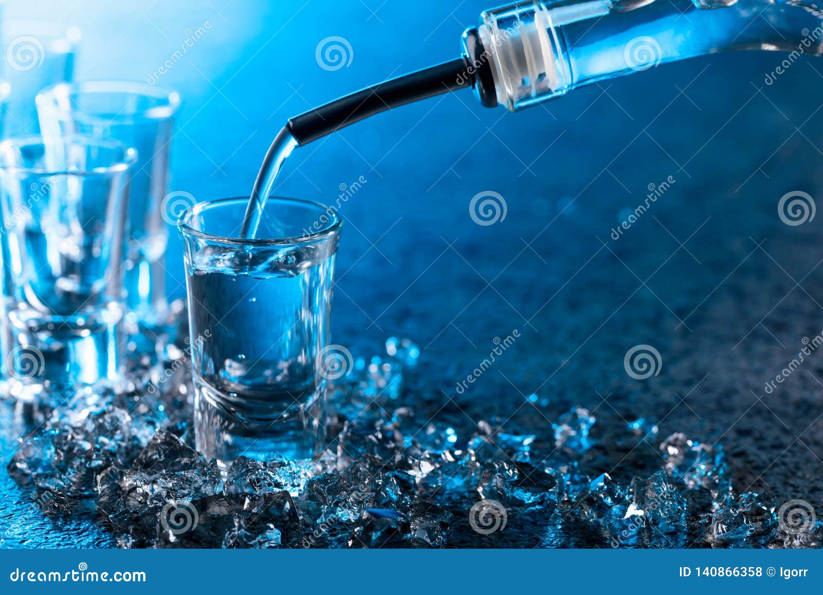 Vodka Poured into a Glass Lit with Blue Backlight Stock Photo - Image ...