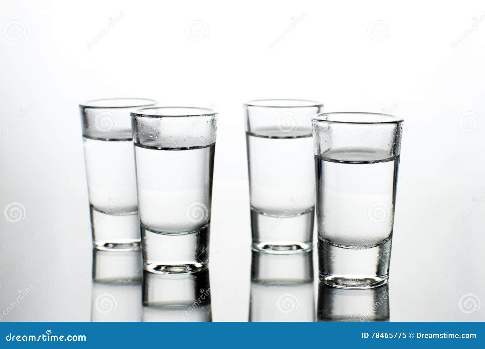 Vodka Shots Filled with Alcohol on Glass Bar Table Stock Image - Image ...
