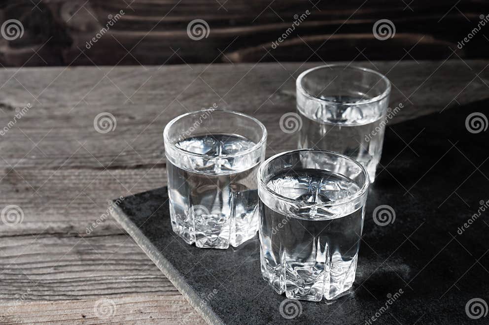Vodka Shots with Ice Cubes on Black Stone, Stock Photo - Image of ...