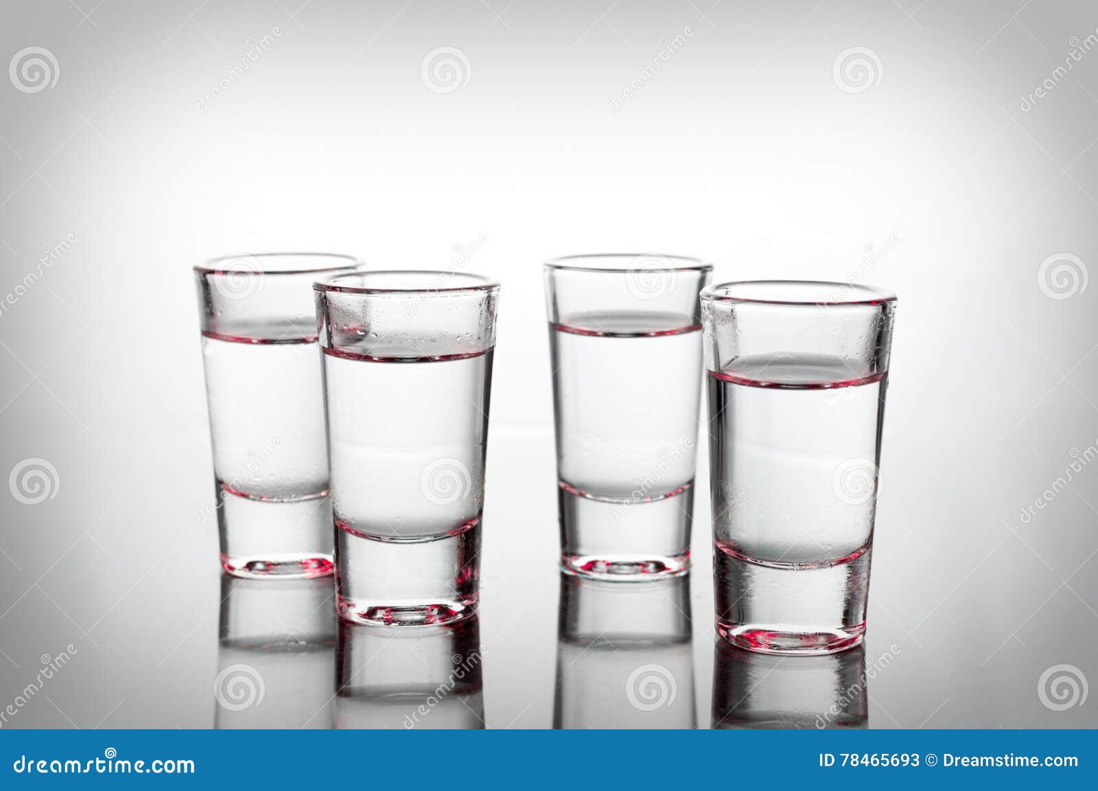 Vodka Shots Lighted with Red Light Filled with Alcohol on Glass Bar ...