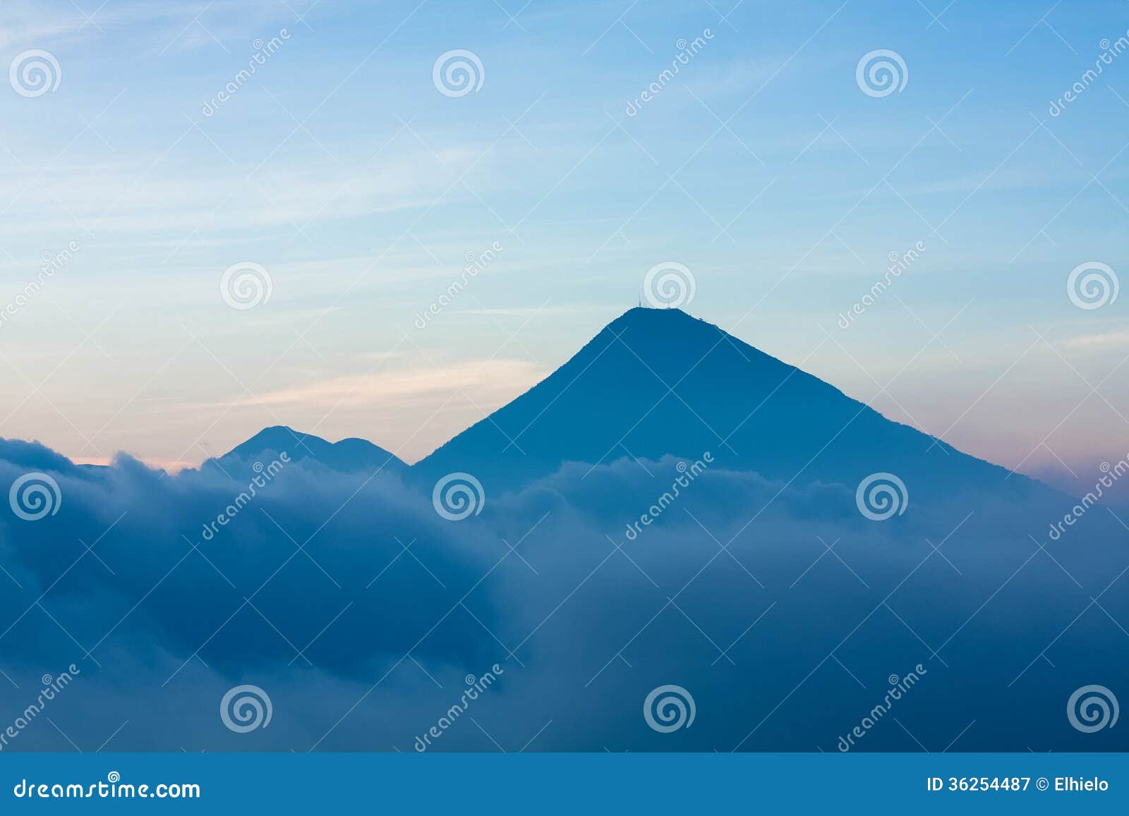 Volcano above clouds stock image. Image of surface, sunlight - 36254487