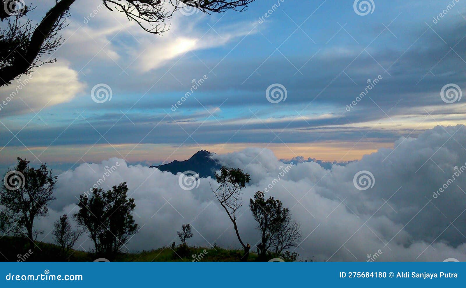 A volcano shrouded in mist stock photo. Image of shrouded - 275684180