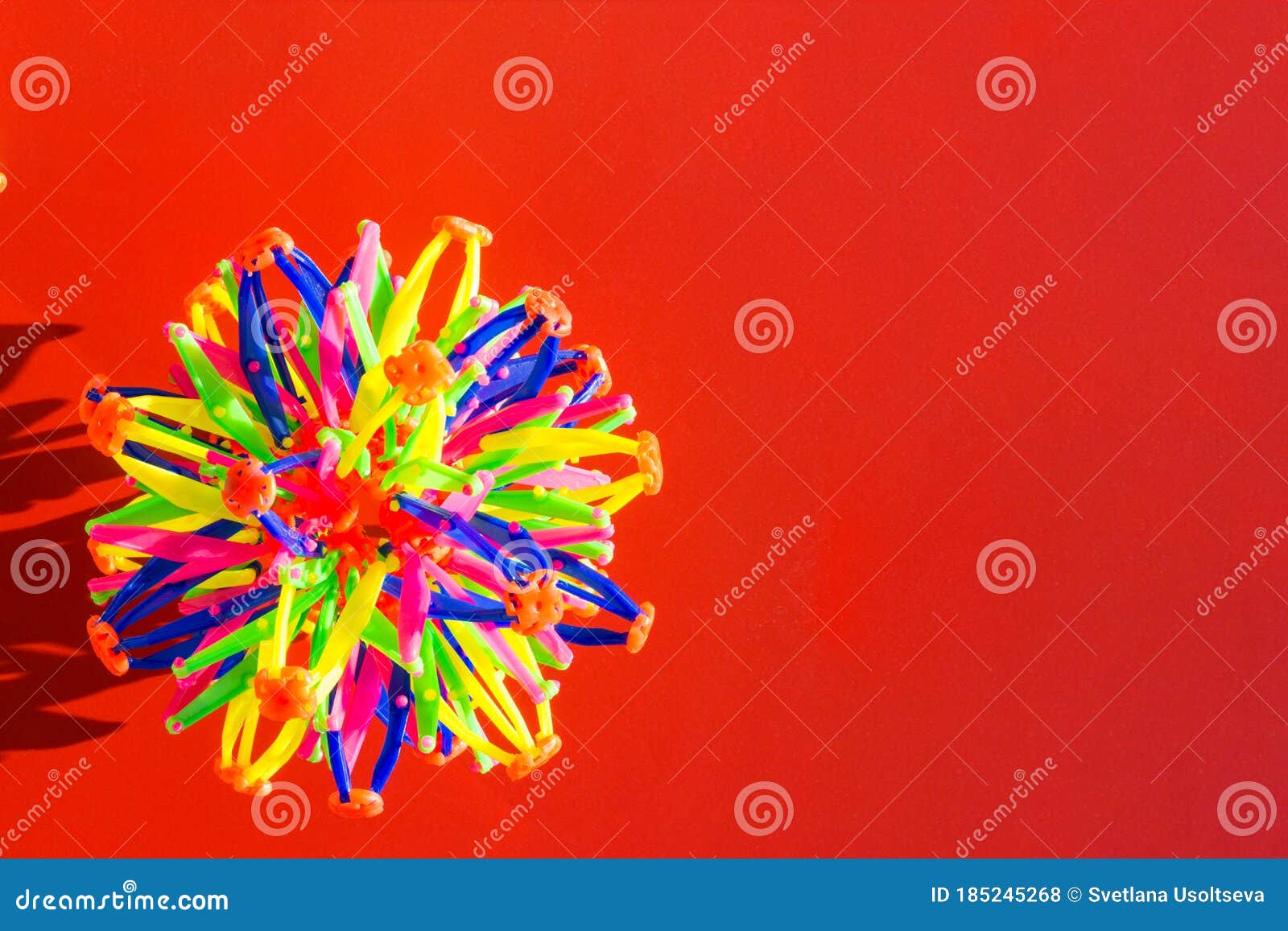 Volumetric Multi-colored Ball Made of Plastic Sticks on a Red ...
