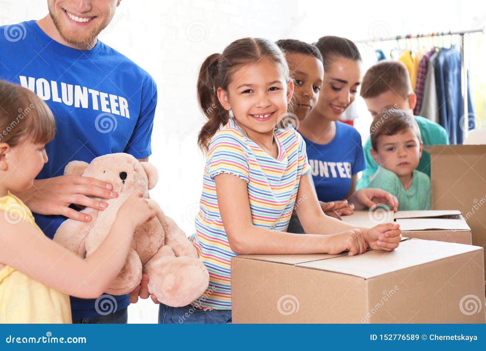 Volunteers with Children Sorting Donation Goods Stock Image - Image of ...