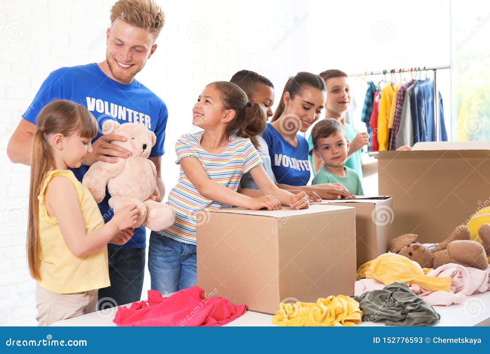 Volunteers with Children Sorting Donation Goods Stock Image - Image of ...