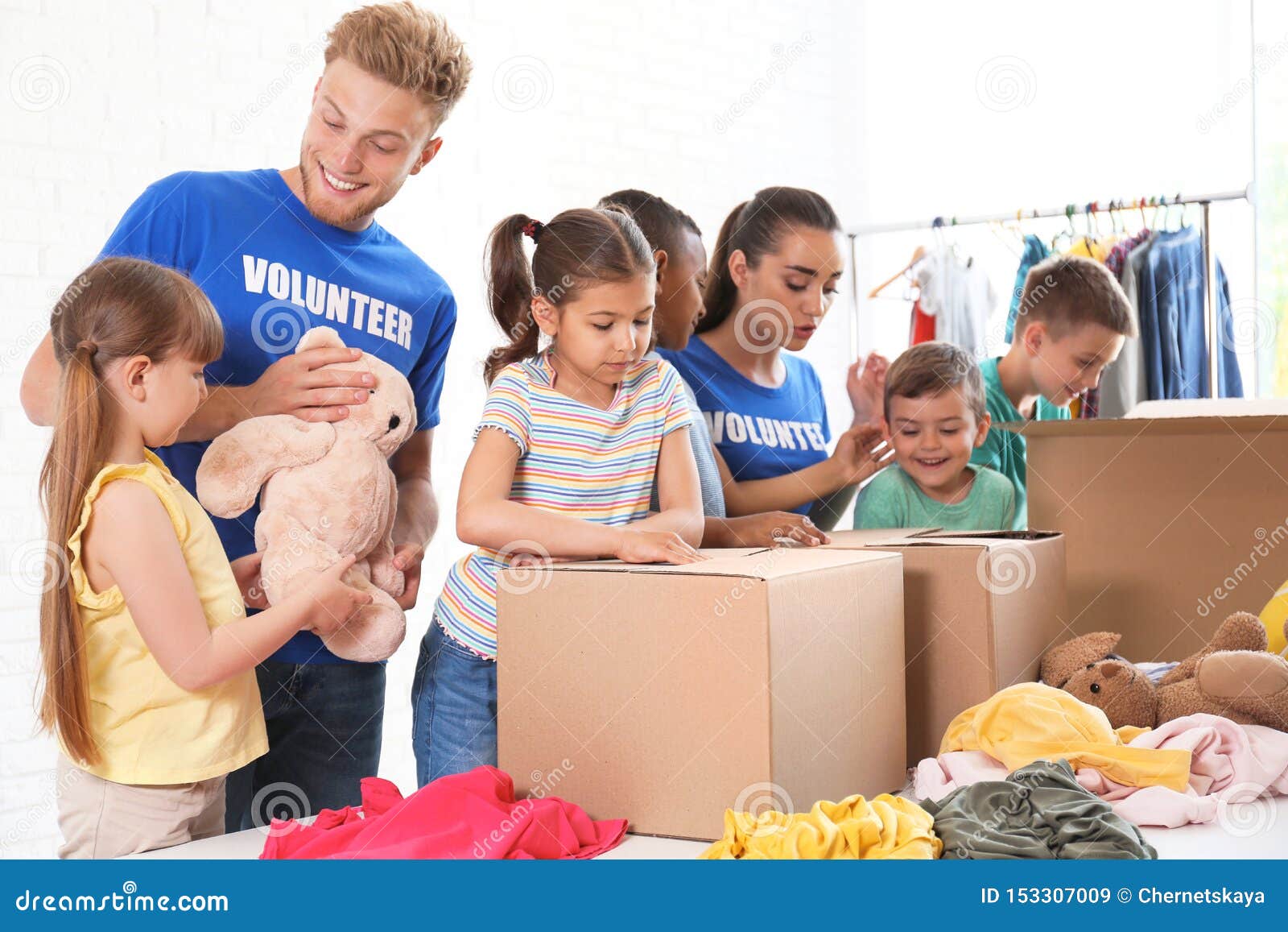 Volunteers with Children Sorting Donation Goods Stock Image - Image of ...