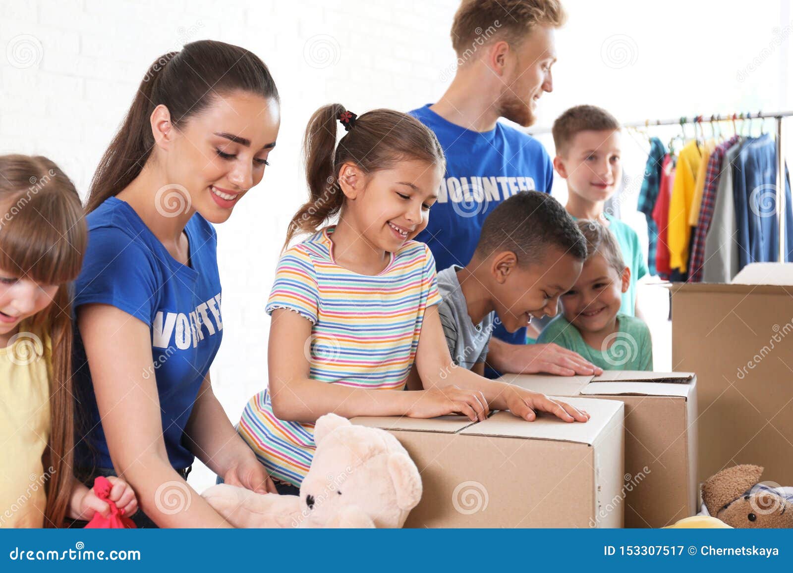 Volunteers with Children Sorting Donation Goods Stock Image - Image of ...