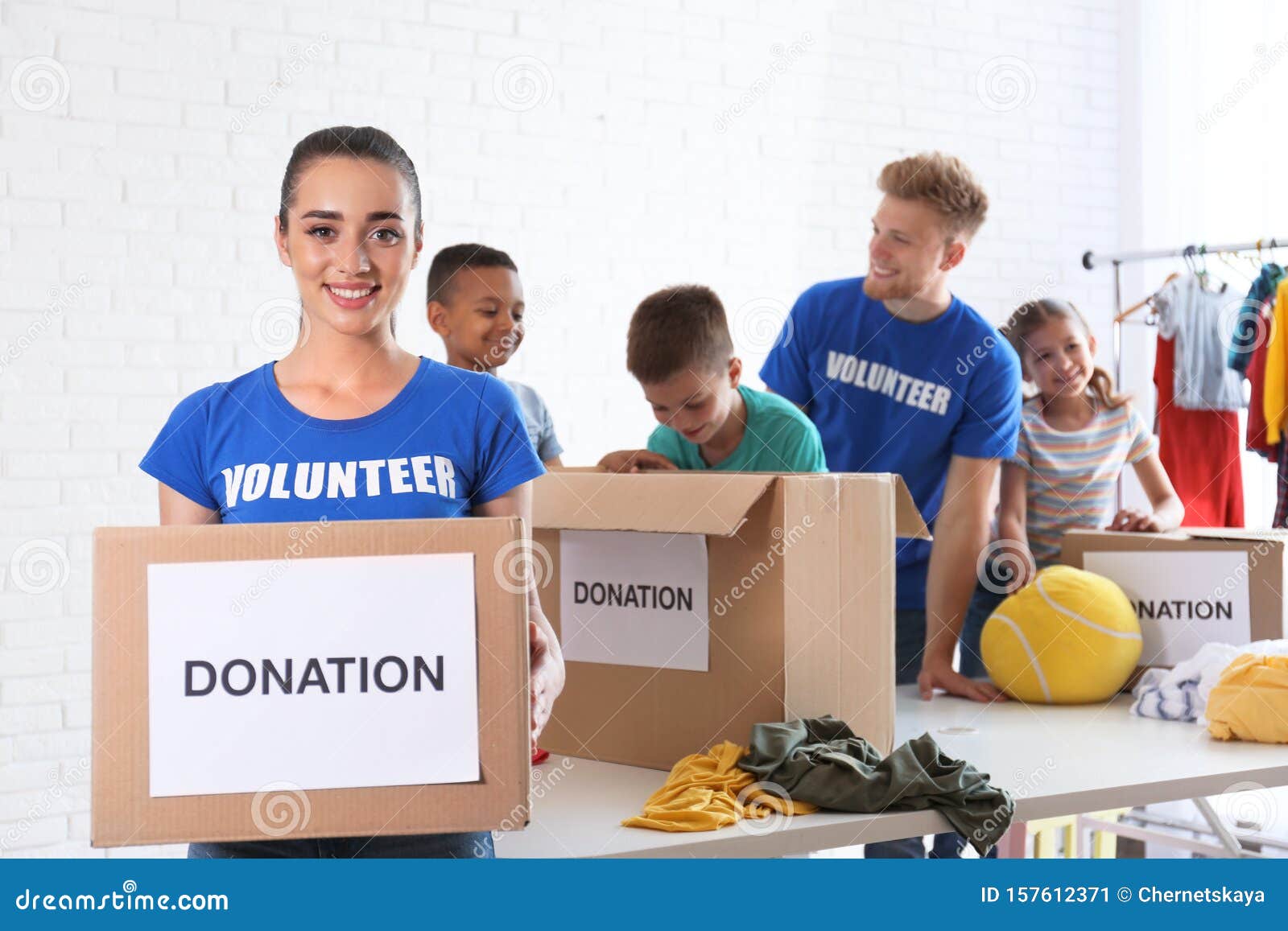 Volunteers with Children Sorting Donation Goods Stock Image - Image of ...