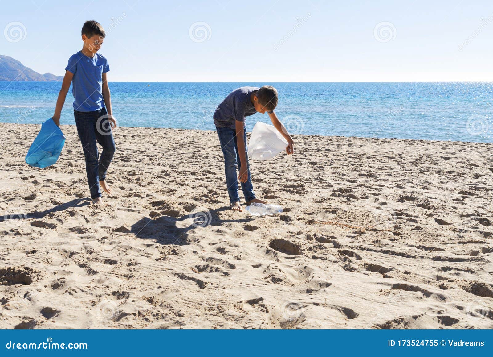 Volunteers Cleaning Beach from Plastic. Boys Walking on the Beach and ... Volunteers Cleaning Beach from Plastic. Boys Walking on the Beach and ...