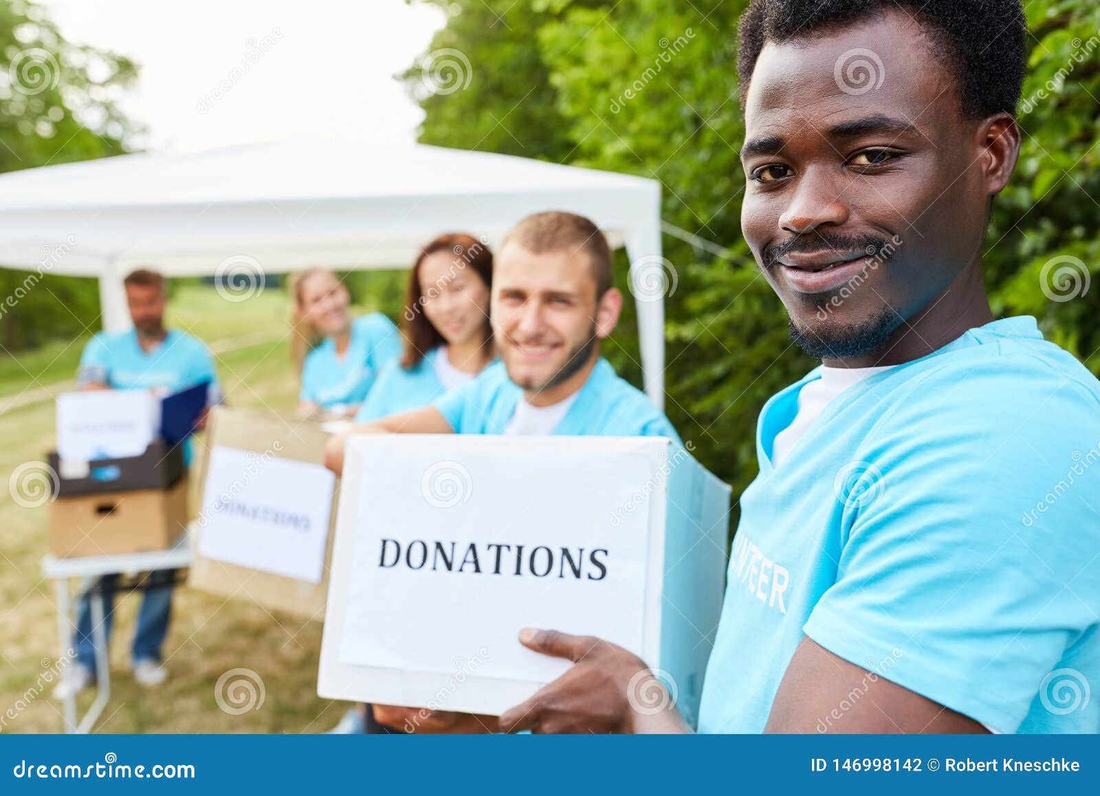 Volunteers work as a team stock photo. Image of smile - 146998142