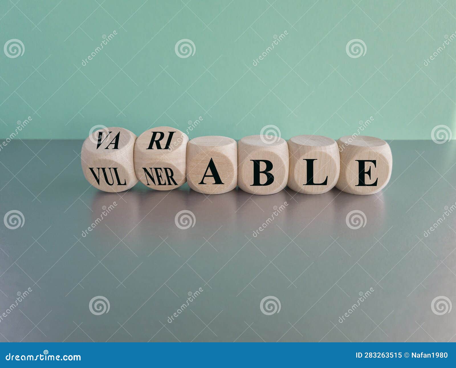 Vulnerable or Variable Symbol. Turned Wooden Cubes and Changes the Word ...