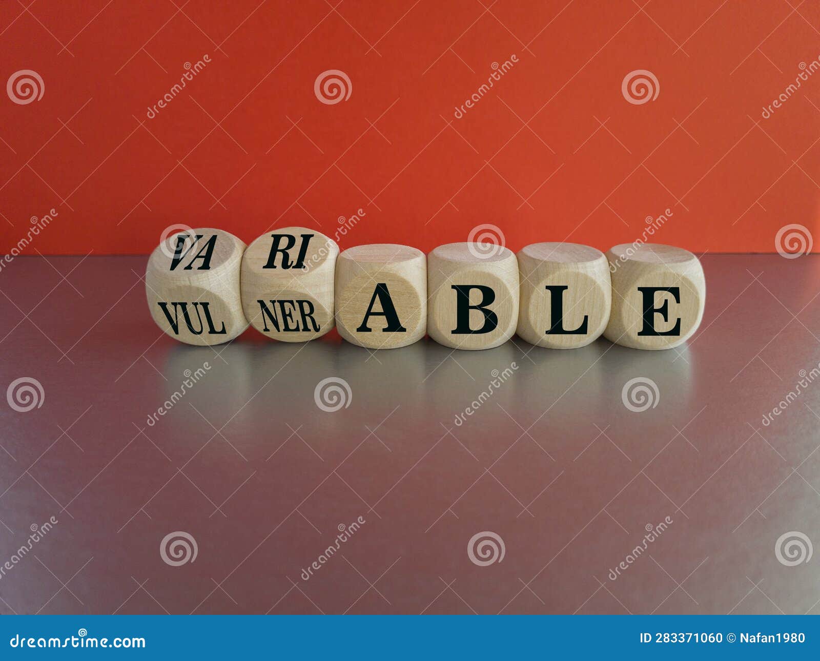 Vulnerable or Variable Symbol. Turned Wooden Cubes and Changes the Word ...
