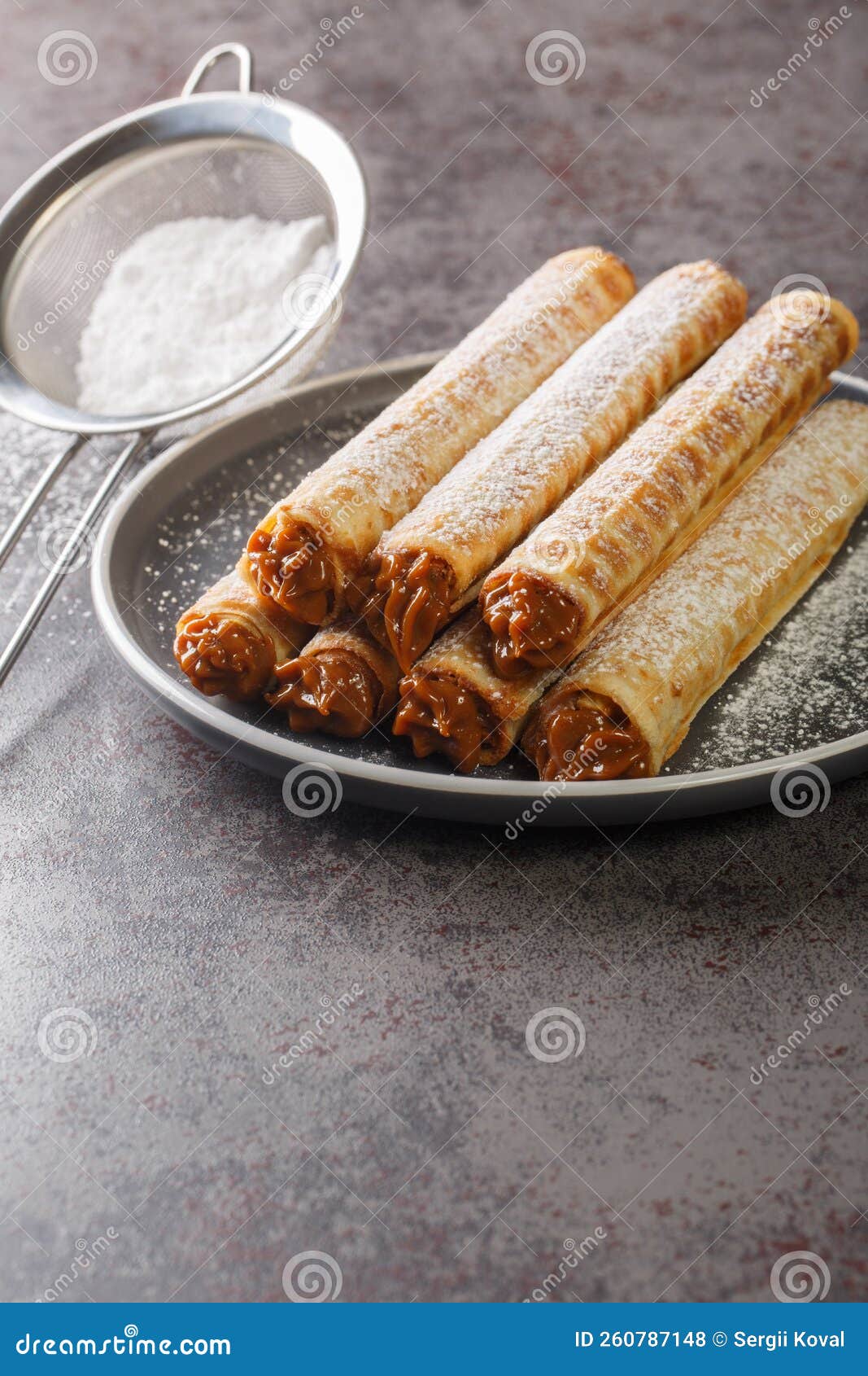 Waffles Cones with Boiled Condensed Milk in Plate on Table. Vertical ...