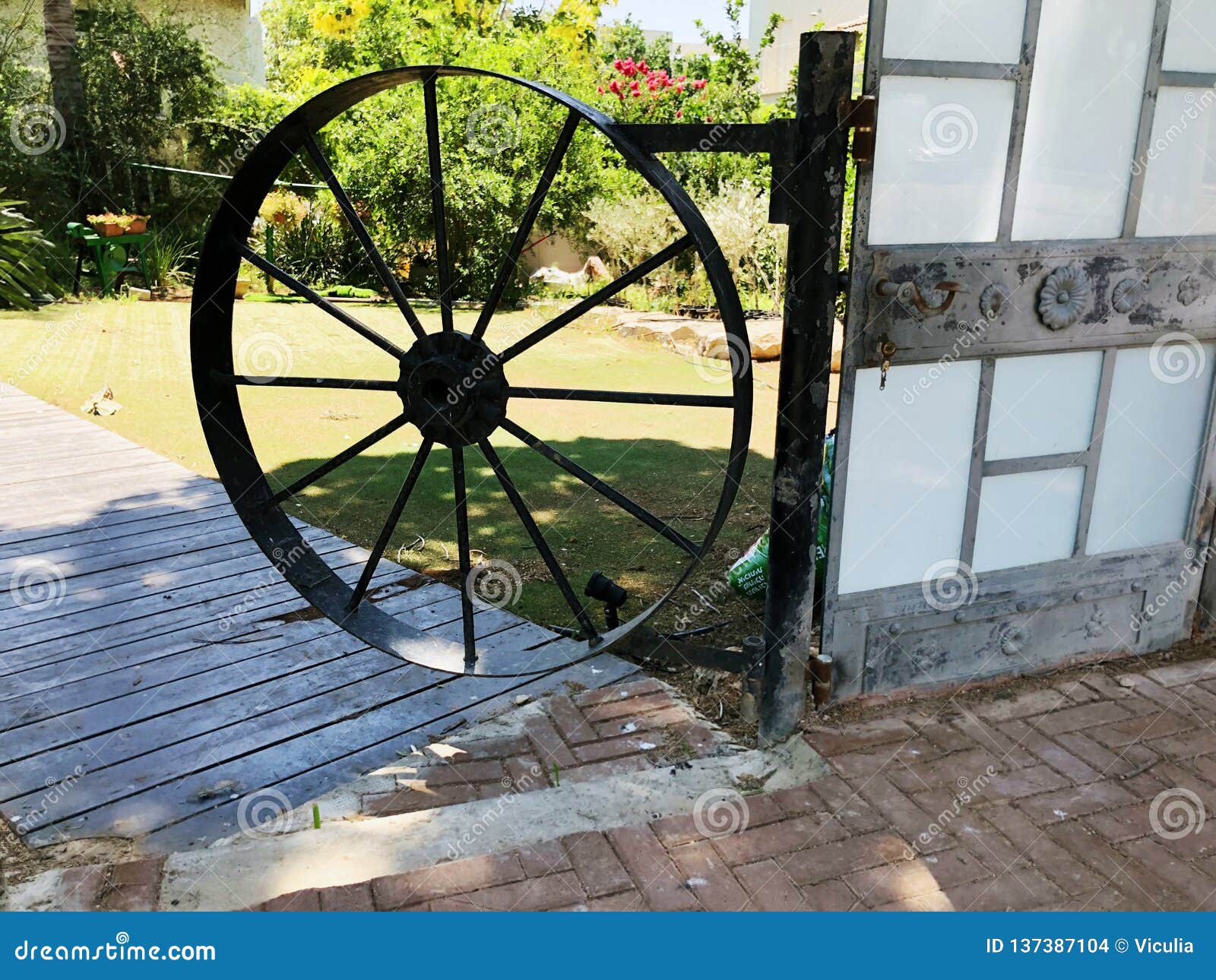 Wagon Wheel Gate on the Background of Green Trees Stock Photo - Image ...