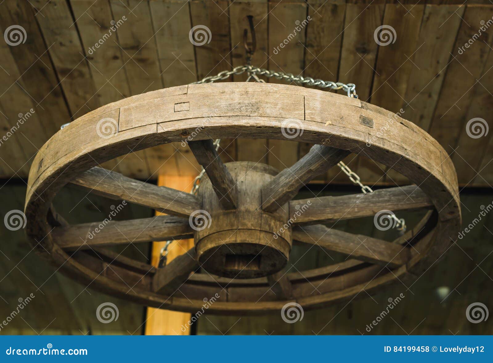 Wagon wheel hanging stock photo. Image of surface, abandoned - 84199458