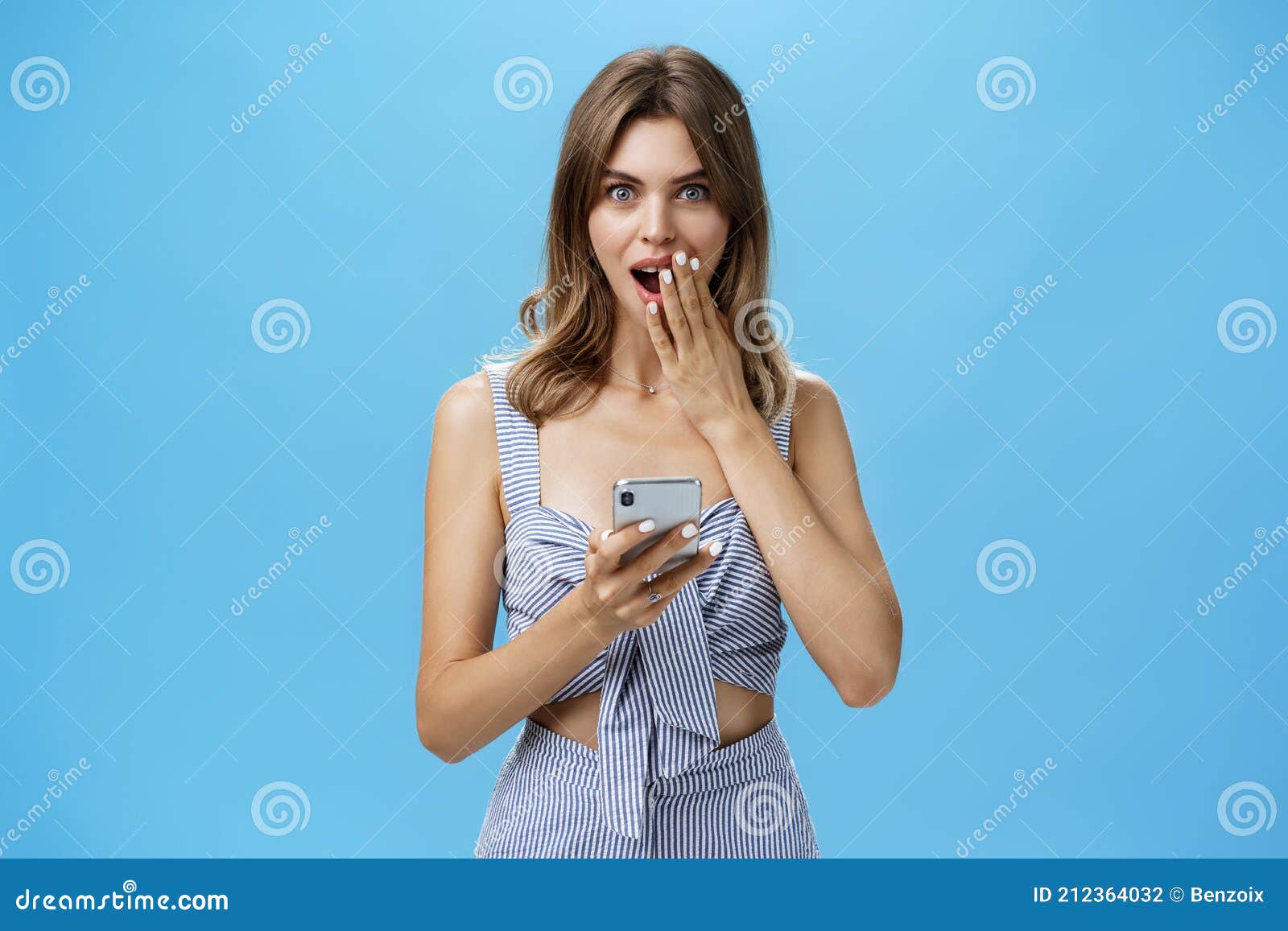 Waist Up Shot Of Surprised And Excited Attractive Woman Holding