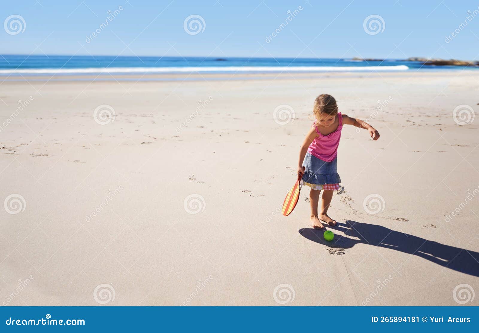 Wait, Come Back. a Cute Little Girl Playing with a Paddle Bat on the ...