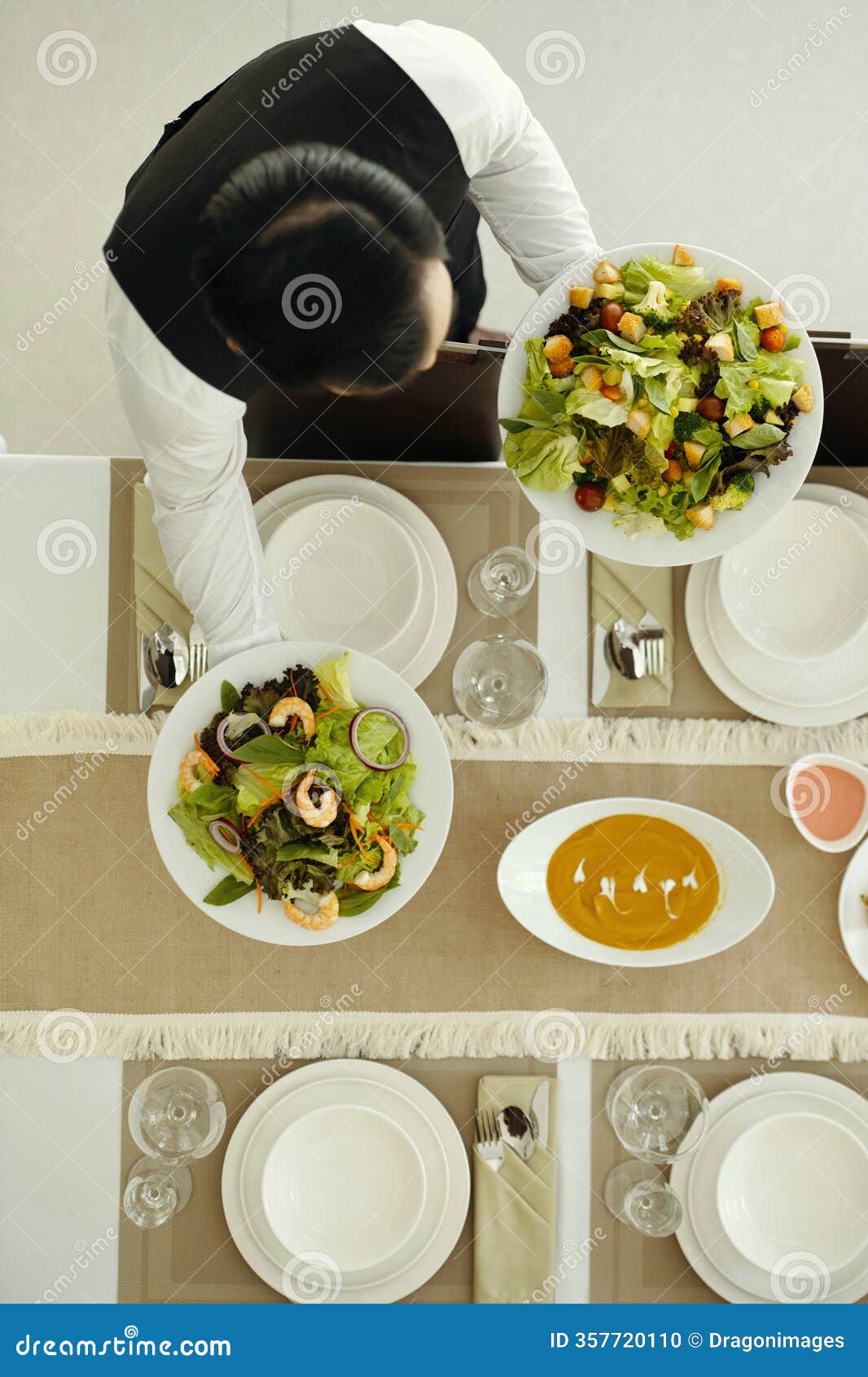 Waiter Arranging Salad on Dining Table Stock Photo - Image of dish ...
