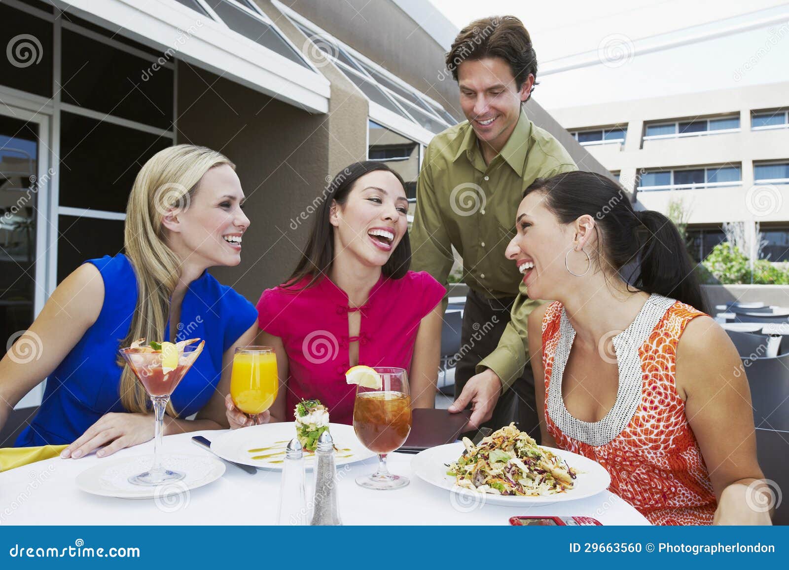 Waiter Bringing Check To Women in Restaurant Stock Photo - Image of ...