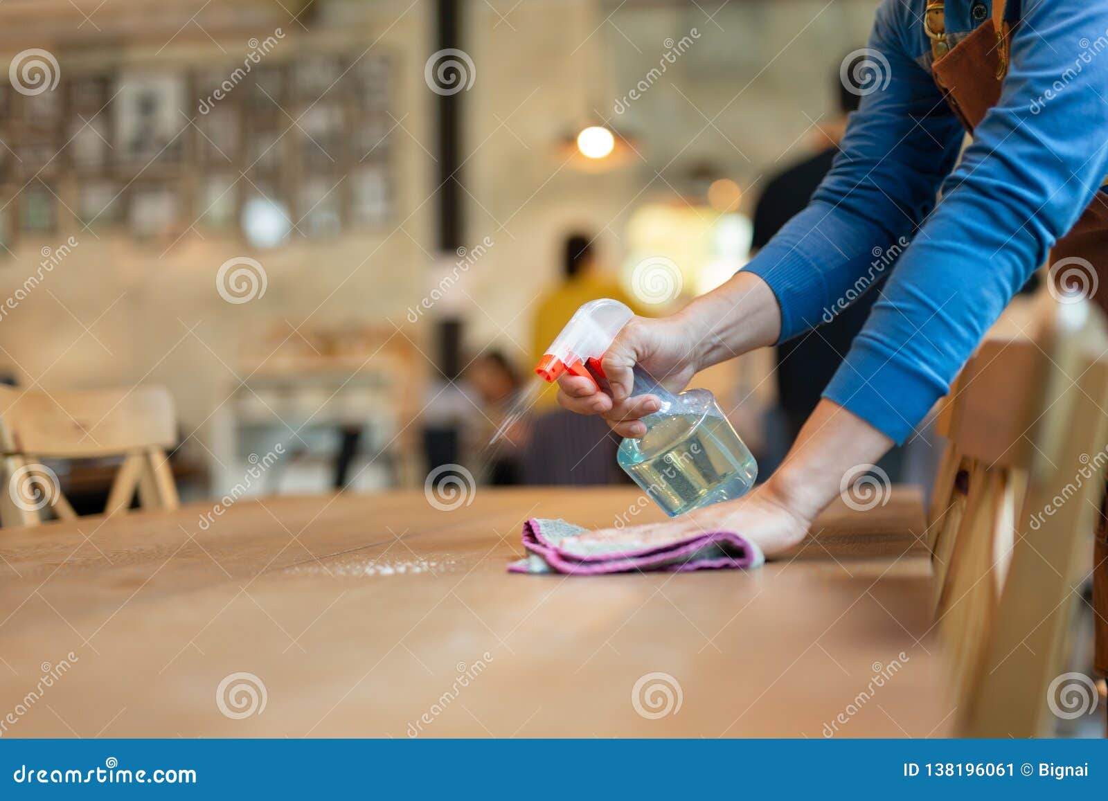 Waiter Cleaning the Table with Spray Disinfectant on Table in ...