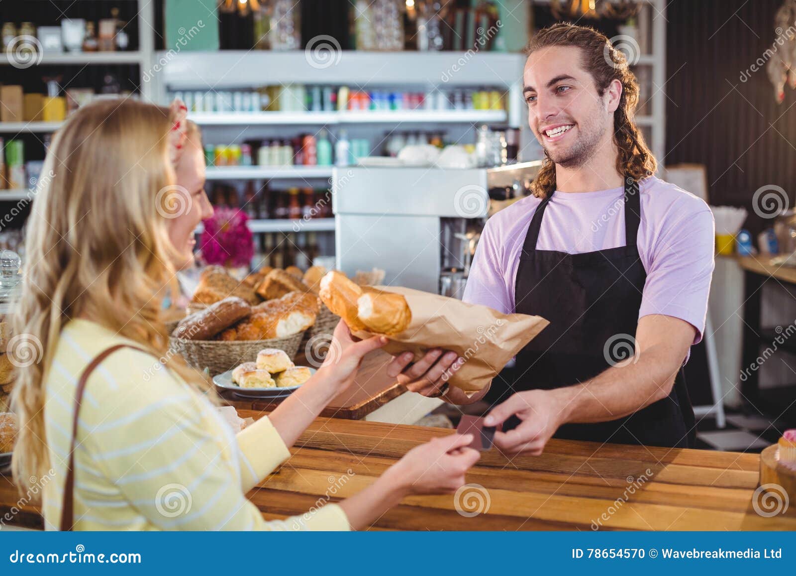 Waiter Giving Bread Roll To Customer at Counter Stock Photo - Image of ...