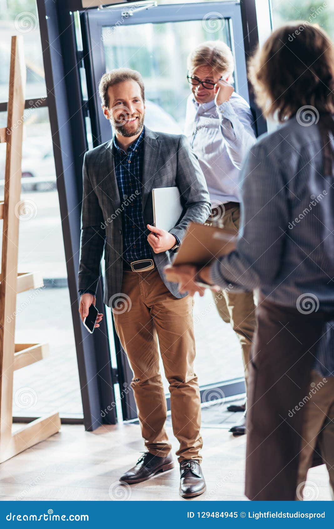 Back View of Waiter Greeting Handsome Smiling Businessmen Stock Image ...