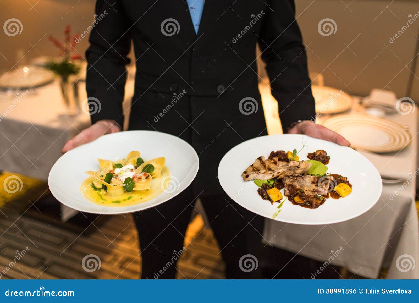Waiter Holds Plates with Food Stock Photo - Image of plates, garnish ...