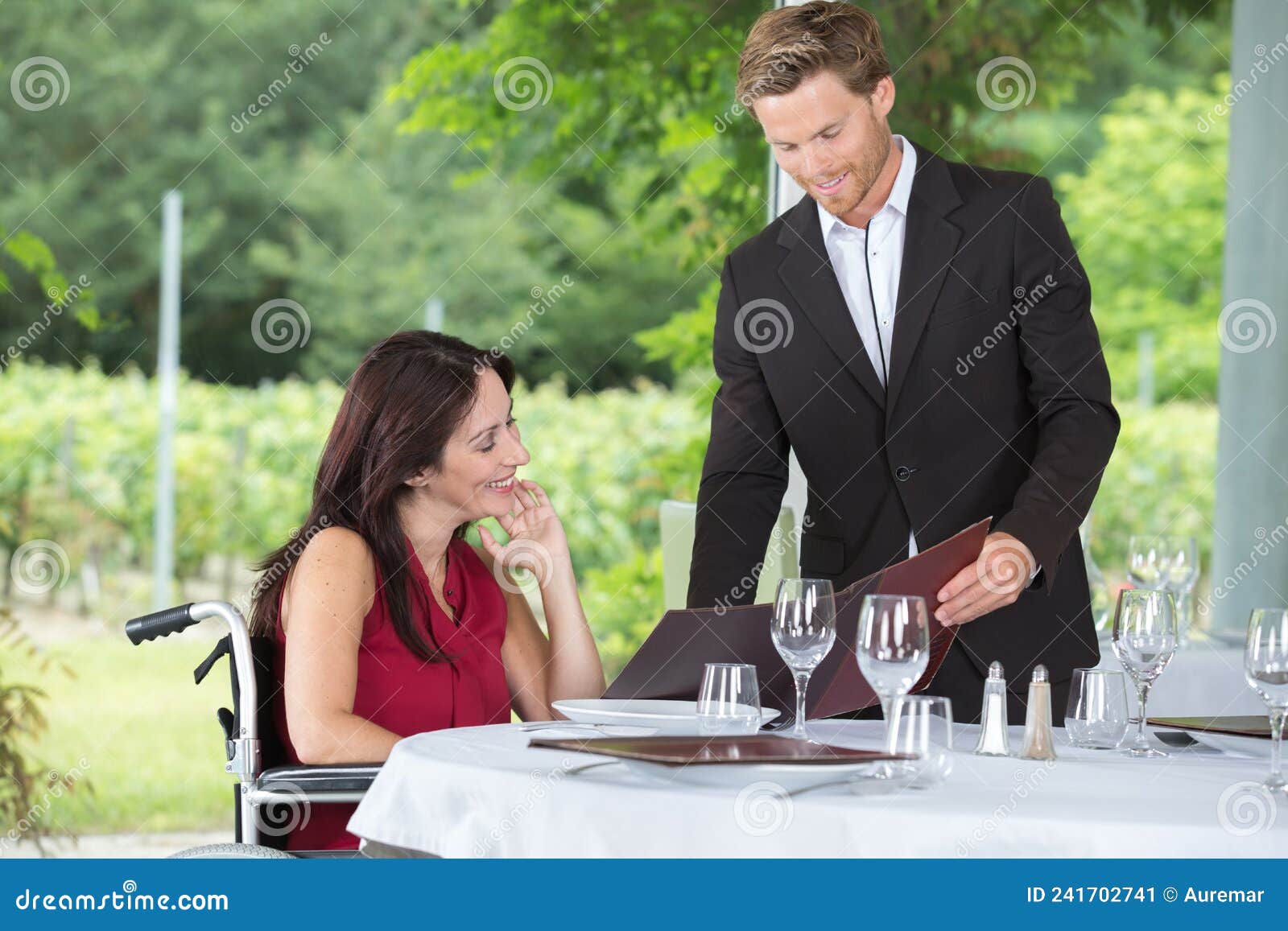 Waiter Opening Menu for Disabled Diner Stock Image - Image of ...