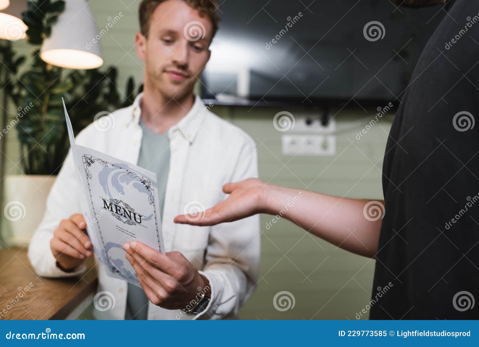 Waiter Pointing at Menu in Hands Stock Image - Image of lettering ...
