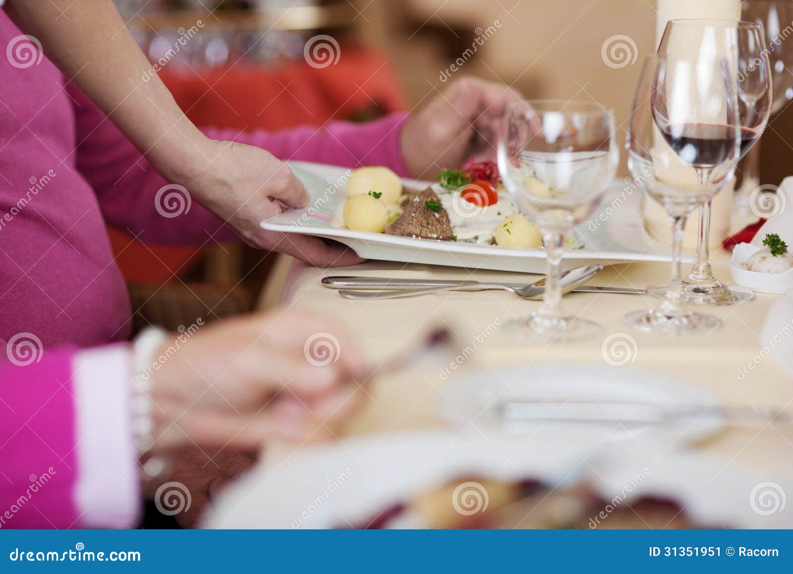 Waiter S Hand Serving Dish To Customers at Restaurant Table Stock Image ...