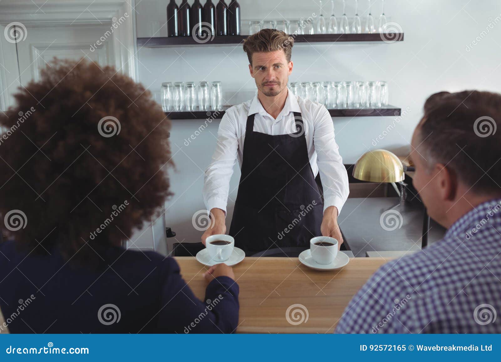 Waiter Serving Coffee To Costumer at Counter Stock Image - Image of ...