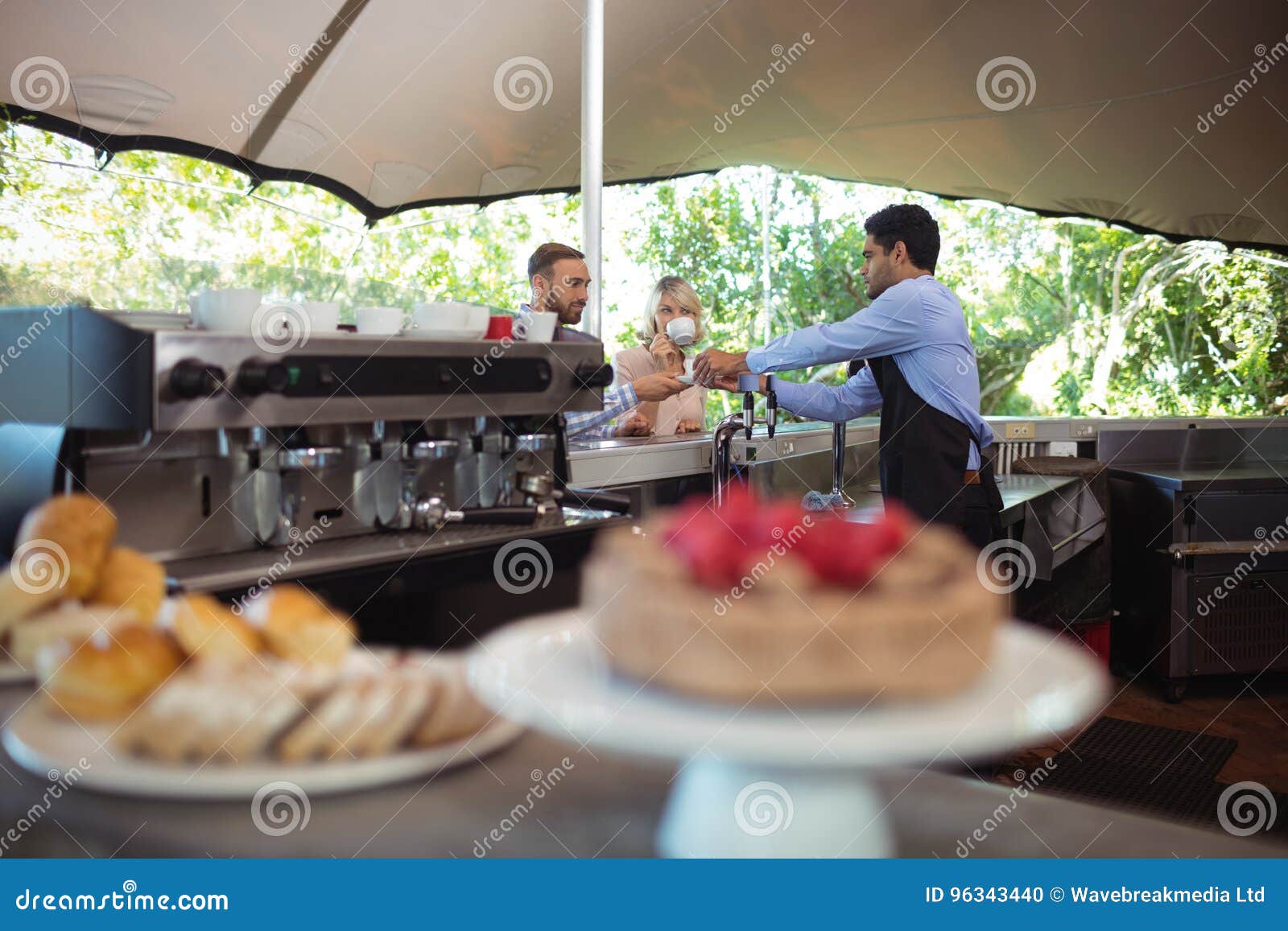 Waiter Serving Coffee To Customer at Counter Stock Photo - Image of ...