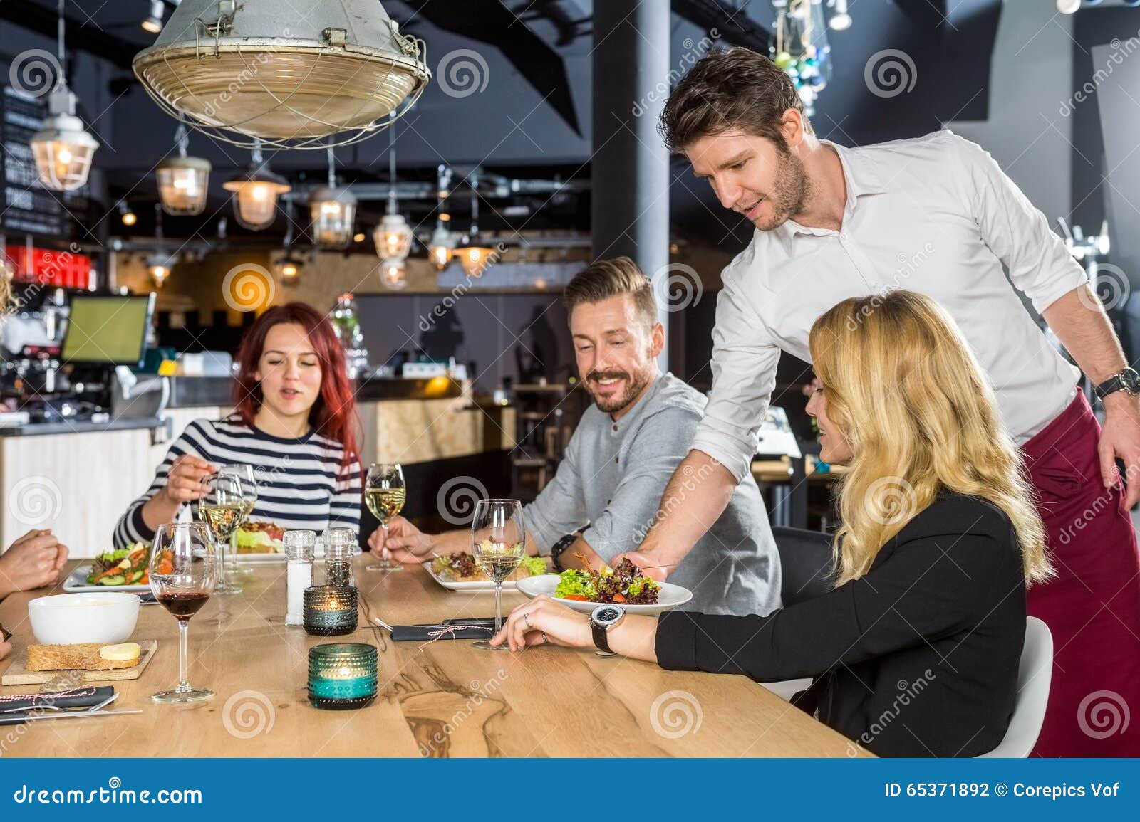 Waiter Serving Food To Customers in Cafe Stock Photo - Image of serving ...