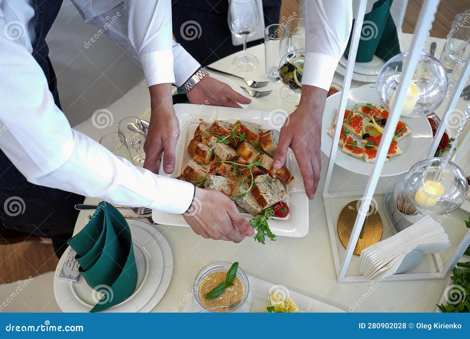 Waiter Serving a Plate of Stuffed Chicken on a Banquet Table Stock ...