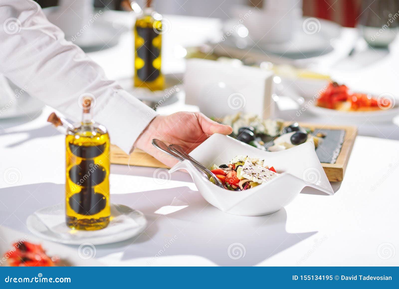 Waiter Serving Table in the Restaurant Preparing To Receive Guests ...