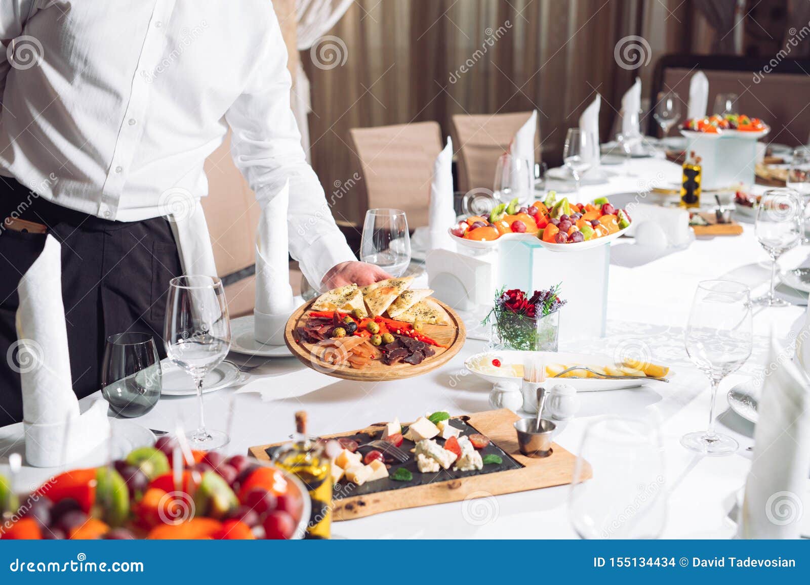 Waiter Serving Table in the Restaurant Preparing To Receive Guests ...