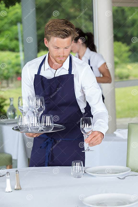 Waiter Setting Table in Bar Stock Image - Image of restaurant, layout ...