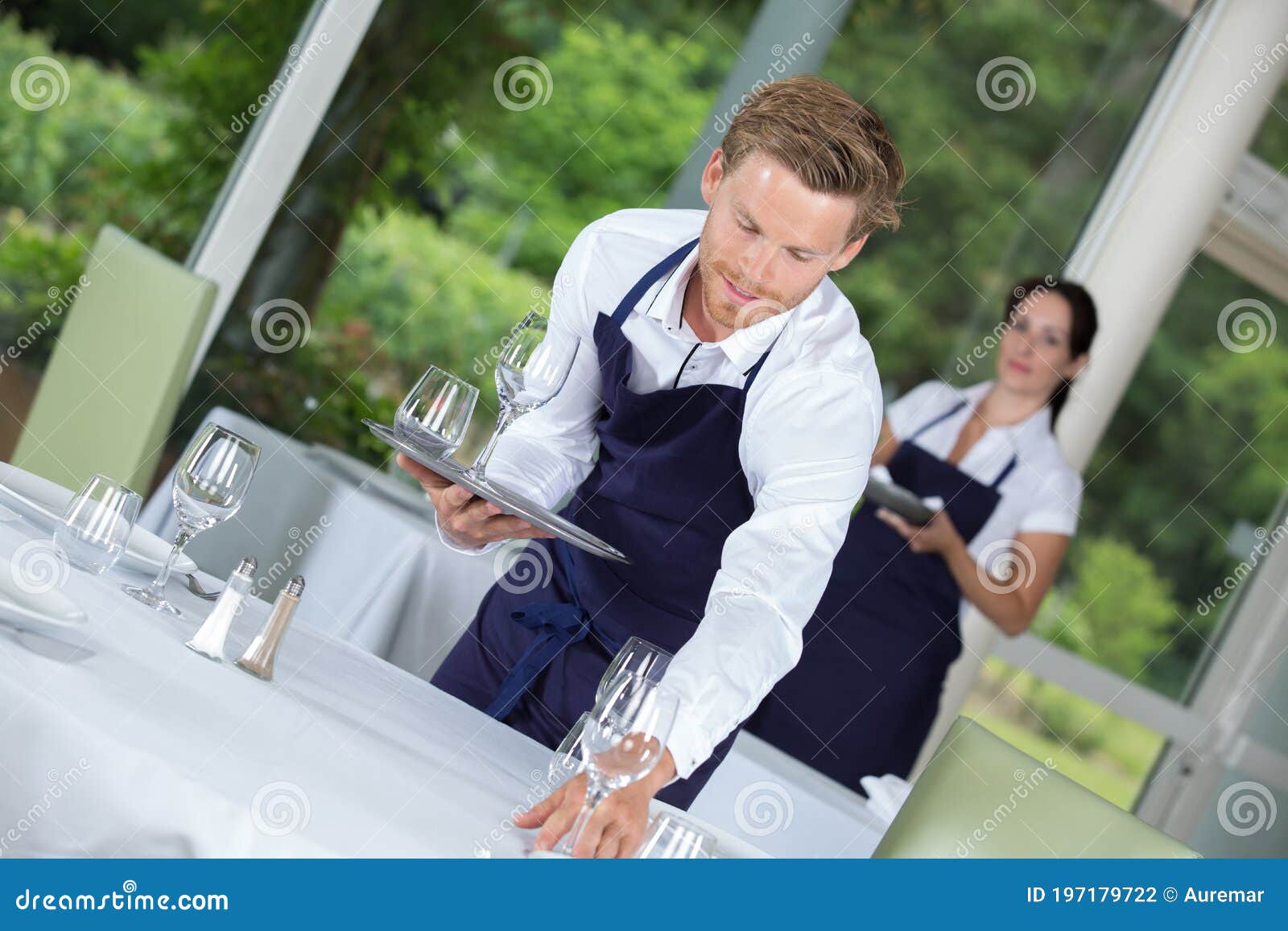 Waiter Setting Table in Restaurant Stock Photo - Image of cutlery ...