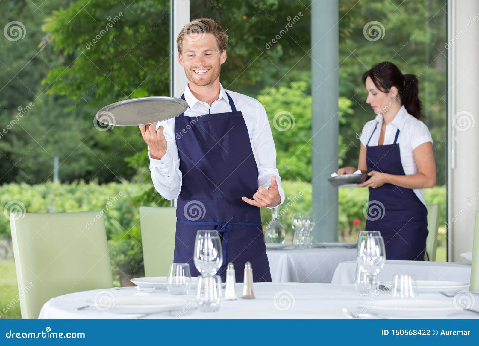 Waiter setting up table stock photo. Image of modern - 150568422