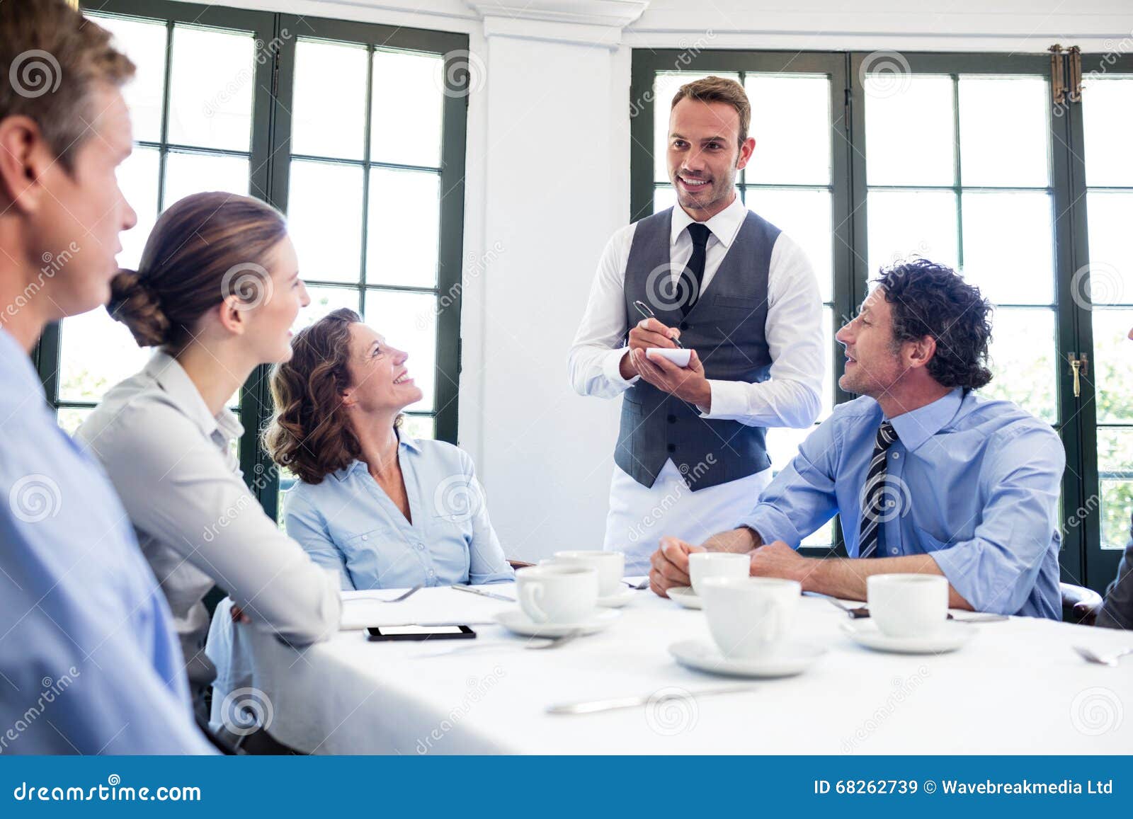 Waiter taking an order stock image. Image of adult, digital - 68262739