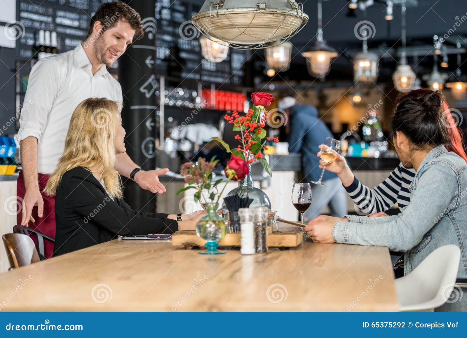Waiter Taking Order from Customers in Cafe Stock Photo - Image of ...