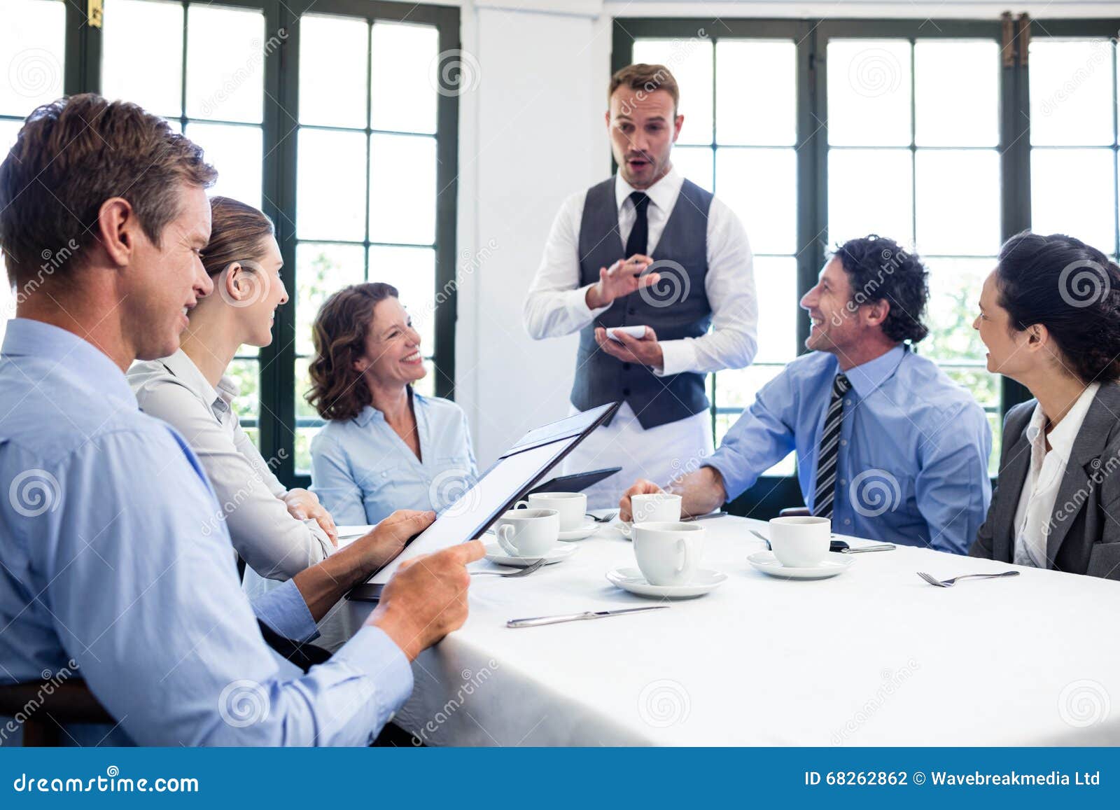 Waiter taking an order stock photo. Image of indoors - 68262862