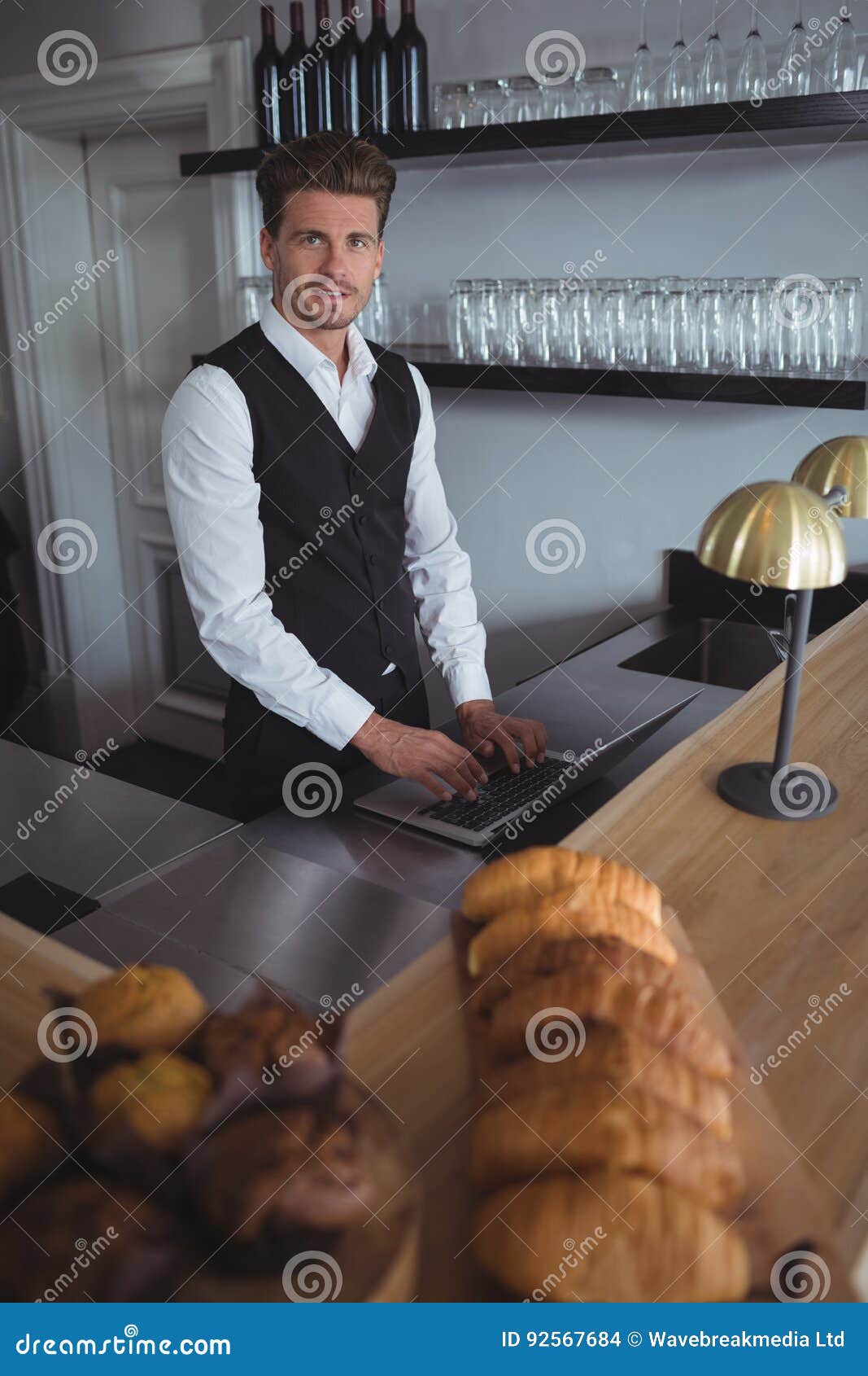 Waiter Using Laptop at Counter Stock Photo - Image of caucasian ...