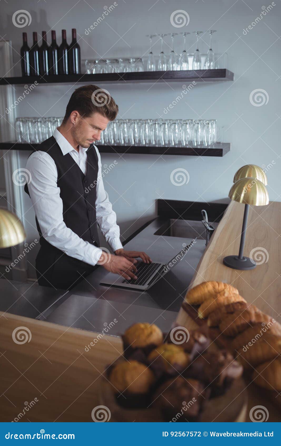 Waiter Using Laptop at Counter Stock Photo - Image of profession ...