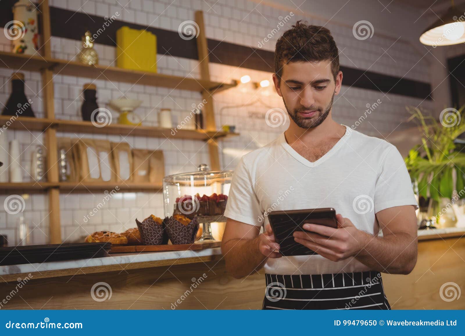 Waiter Using Tablet at Cafe Stock Photo - Image of male, person: 99479650