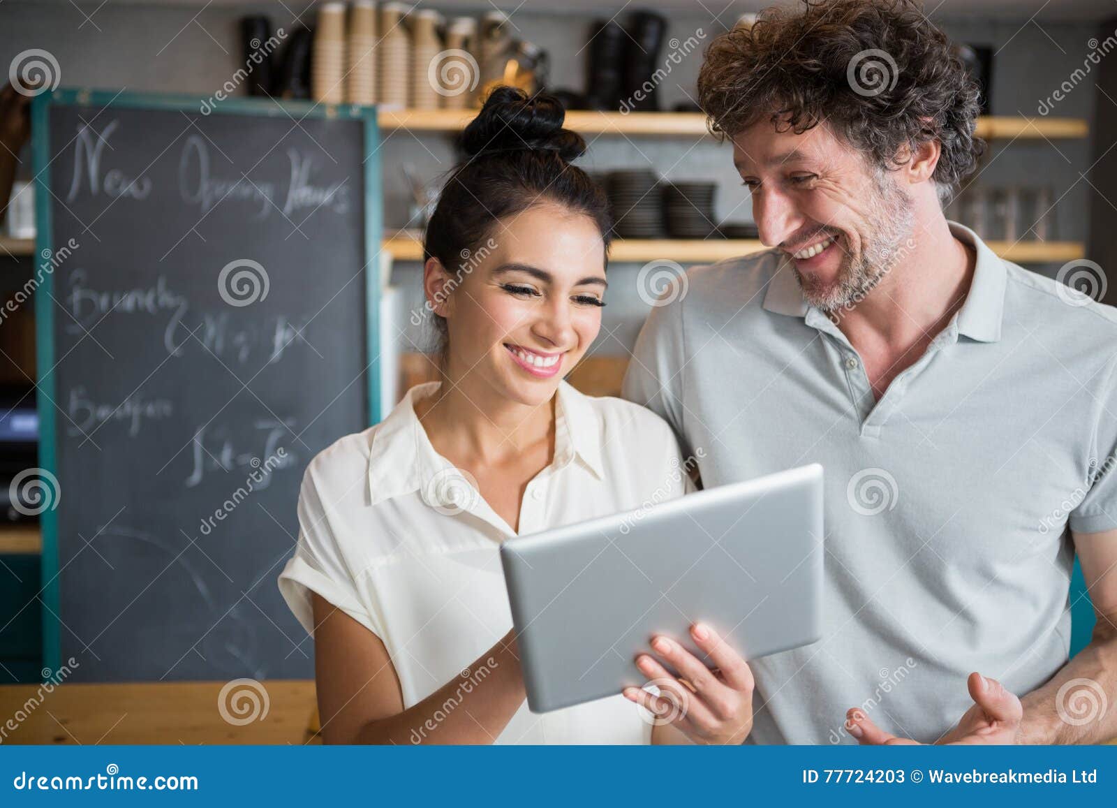 Waiter and Waitress Discussing Over Digital Tablet Stock Image - Image ...