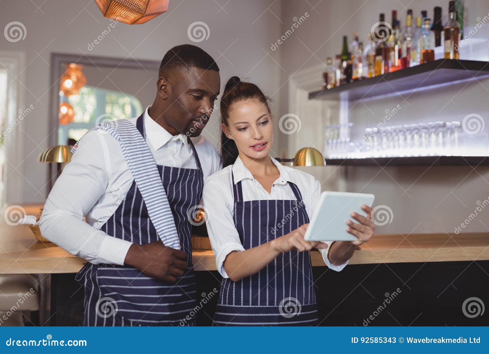 Waiter and Waitress Discussing Over Digital Tablet Stock Image - Image ...