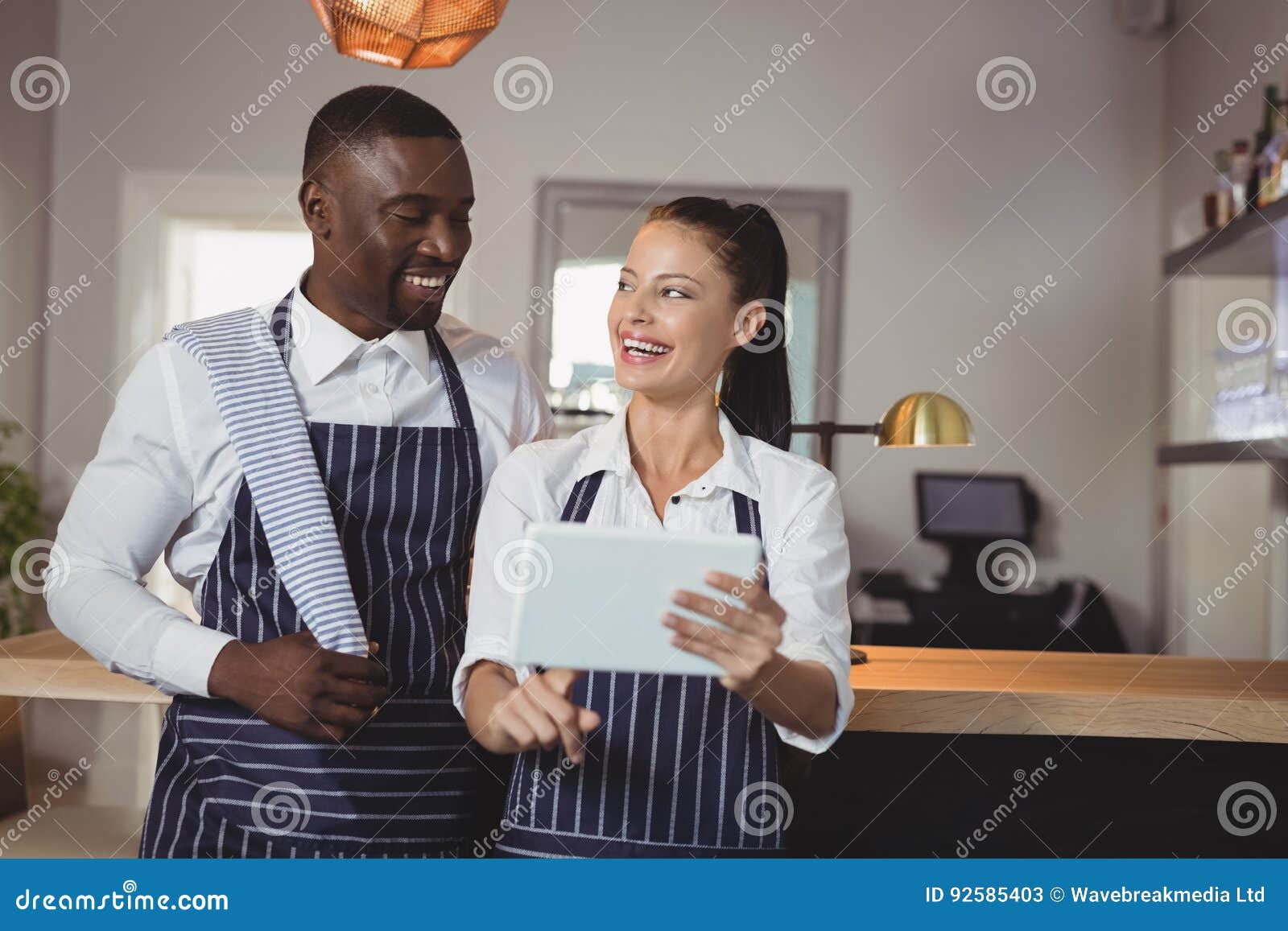 Waiter and Waitress Discussing Over Digital Tablet Stock Image - Image ...