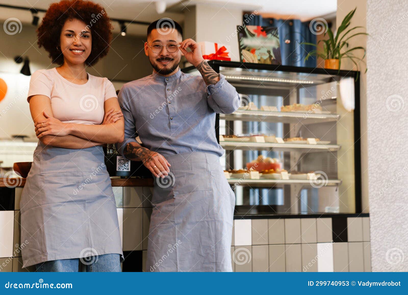 Waiter and Waitress Smiling at Camera while Standing in Cafe Stock ...