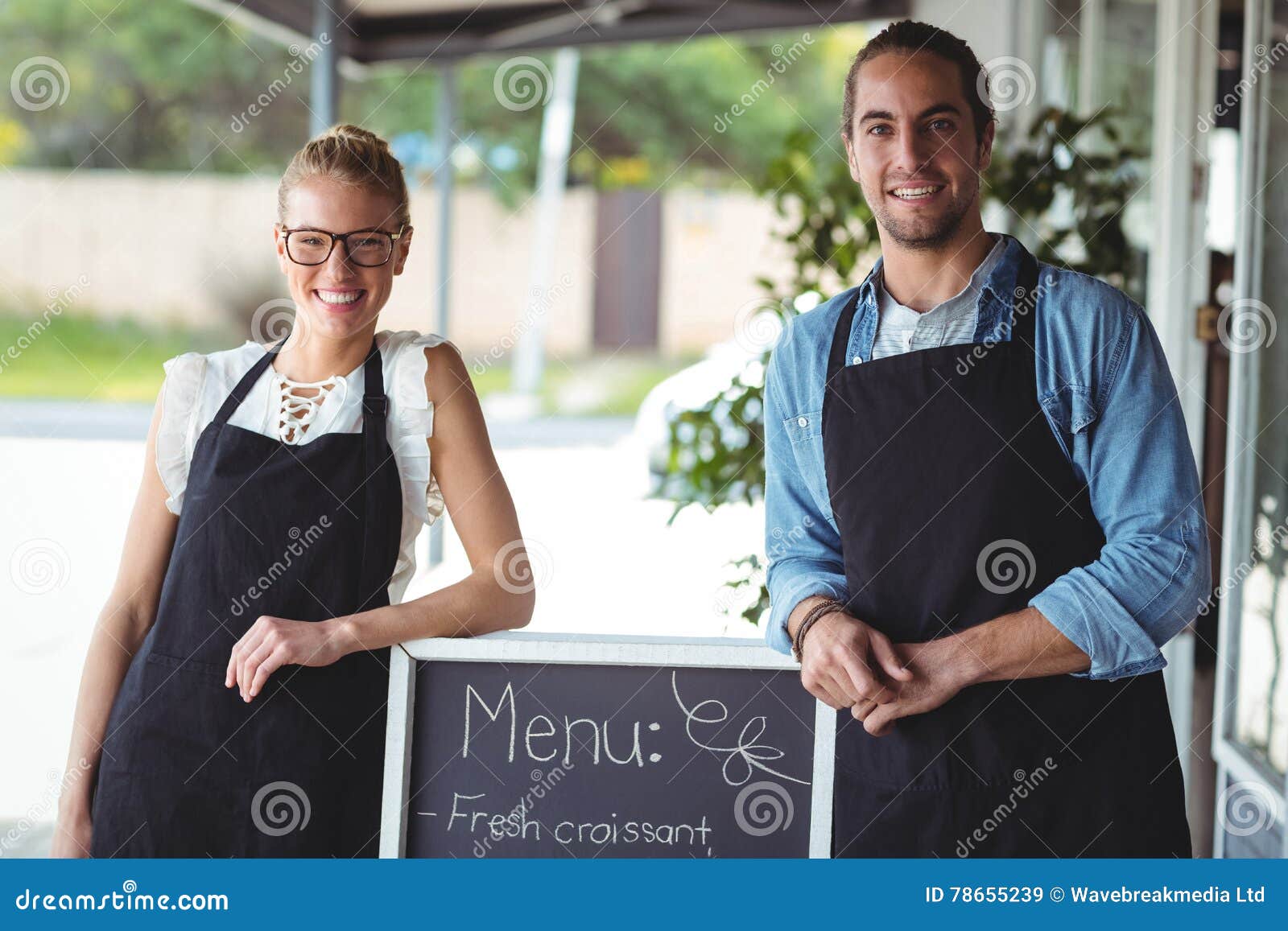 Waiter and Waitress Standing with Menu Board Outside the Cafe Stock ...